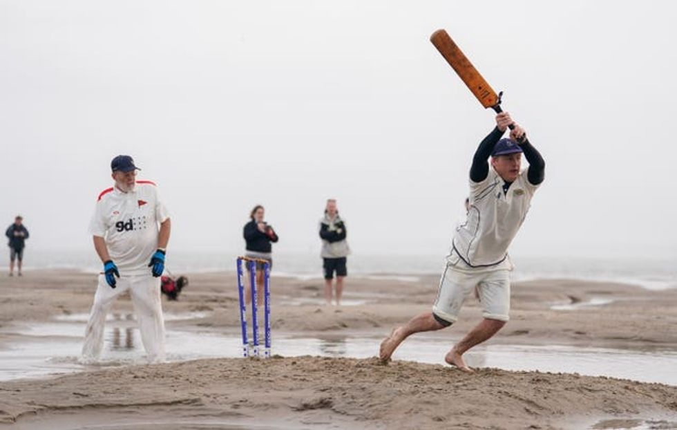 In Pictures: Waves stop play for Solent sandbar cricketers | indy100