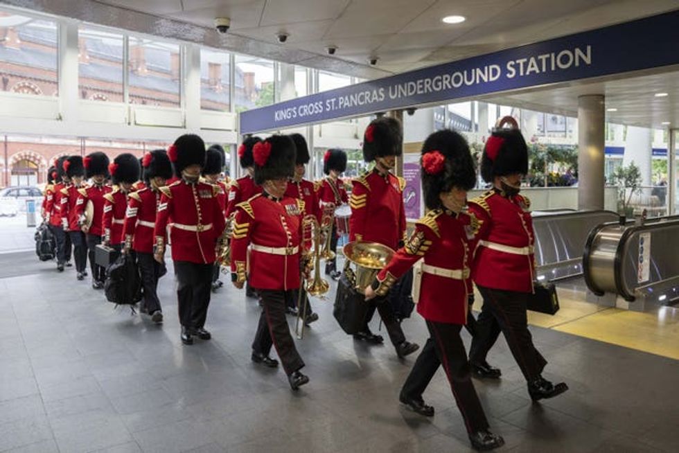 In Pictures: Bearskin caps in the luggage rack as Coldstream Guards return home | indy100