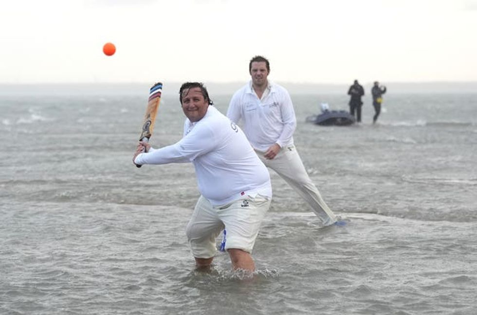 In Pictures: Waterlogged pitch perfect for cricketers playing annual ...