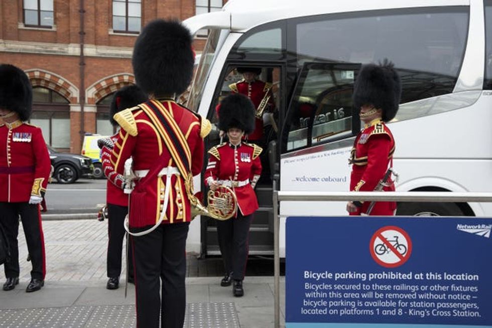 In Pictures: Bearskin caps in the luggage rack as Coldstream Guards return home | indy100
